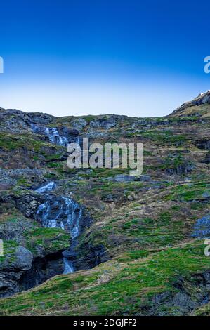 Waterfall free falling from a steep mountain slope Stock Photo - Alamy