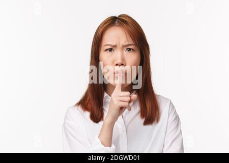Portrait of angry korean girl shushing, woman frowning and tell to be ...