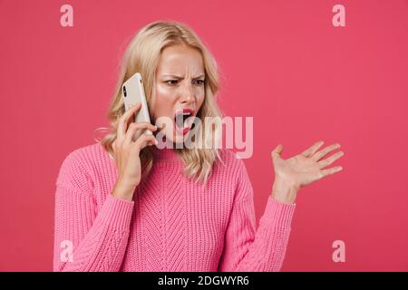 Image of furious blonde girl screaming while holding mobile phone ...