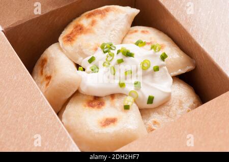 take out pierogi or perogie with sour cream, food truck style Stock ...