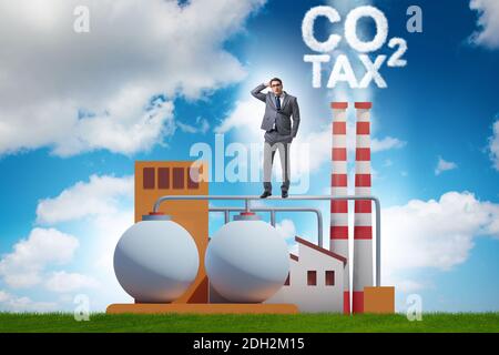 Businessman in the carbon tax concept Stock Photo - Alamy