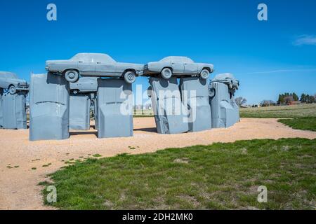 A piled up vintage automobiles all covered with gray spray paint in ...