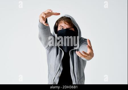 male hacker in a gray sweater stealing black mask on his face Stock ...