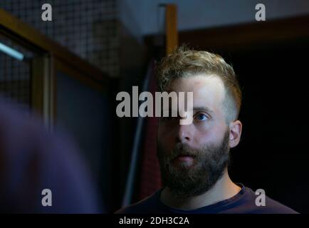 man observing and taking care of himself in front of the bathroom ...