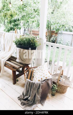 Cozy veranda with bench and flowers Stock Photo - Alamy