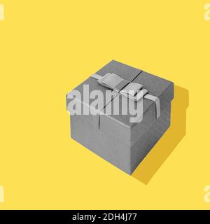 gray-yellow background, birthday gift, gift in red packaging with ...