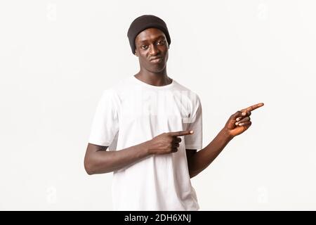 Portrait of skeptical and judgemental african-american guy in beanie ...