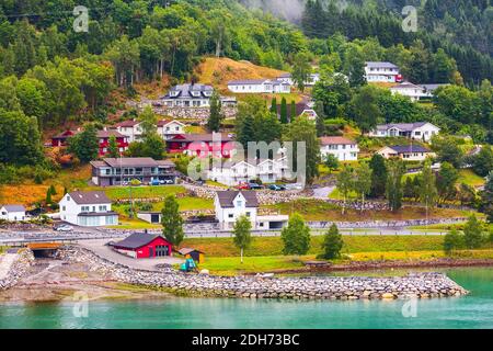 Norwegian village landscape with turquoise fjord water, mountains and ...