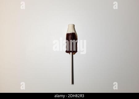 Coke bottle-shaped cola flavored lollipops Stock Photo - Alamy