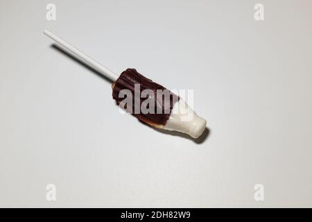 Coke bottle-shaped cola flavored lollipops Stock Photo - Alamy