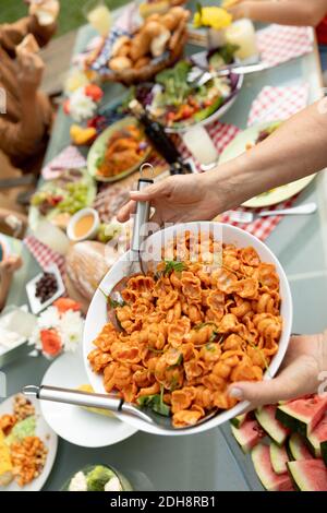 Enjoying a bowl of salad in a sunny outdoor setting Stock Photo - Alamy