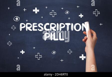 Hand drawing PRESCRIPTION PILL inscription with white chalk on ...