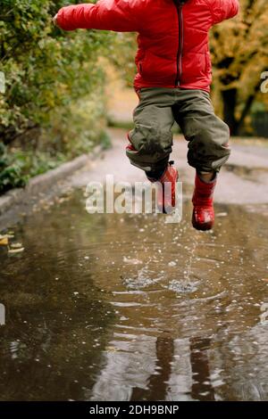 Children jumping in a winter puddle Stock Photo - Alamy