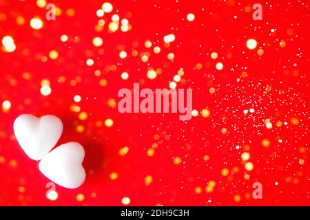 Two white hearts on bright red background and bokeh lights. Valentine's ...