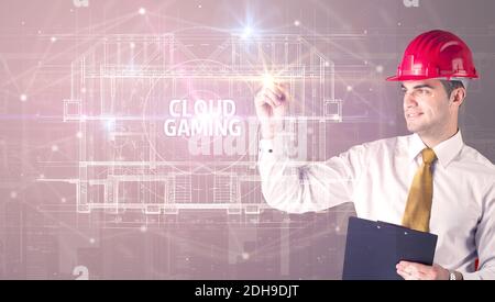 Handsome architect with helmet drawing CLOUD GAMING inscription, new ...