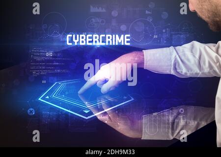 Hand touching digital table with CYBERCRIME inscription, new age ...