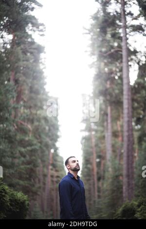 Man looking away while standing against clear sky Stock Photo - Alamy