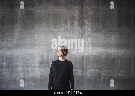 Woman looking away while standing against sky Stock Photo - Alamy