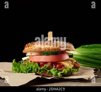 cheeseburger with minced meat, green lettuce and ketchup on a wooden ...