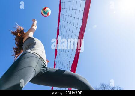 A Gorgeous Redhead Fitness Model Preparing To Play Volleyball Stock ...