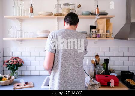 Rear view of man preparing food in barbecue at forest Stock Photo - Alamy