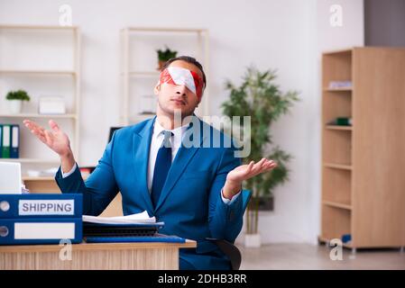 Blindfolded employee working in the office Stock Photo - Alamy