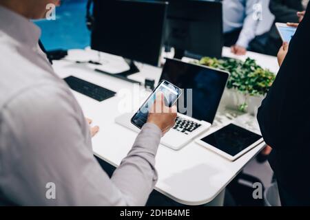 Midsection of businessman using smart phone at airport lobby Stock ...