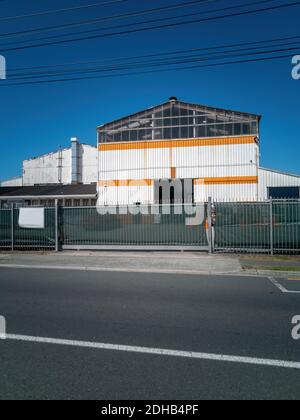 Industrial warehouse behind the fence Stock Photo - Alamy