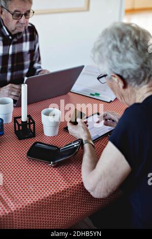 Woman with credit card using laptop at home, closeup Stock Photo - Alamy