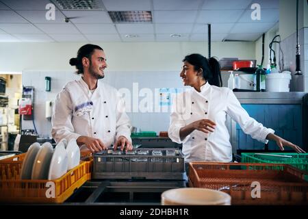 Chefs communicating in commercial kitchen Stock Photo - Alamy