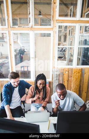 High angle view of smiling programmers discussing at table in creative office Stock Photo - Alamy