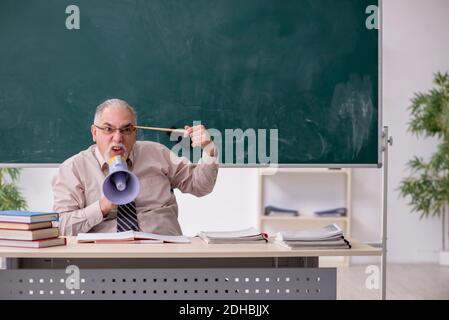senior teacher screaming angry at university classroom Stock Photo - Alamy