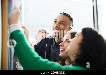 Students checking bulletin board Stock Photo - Alamy