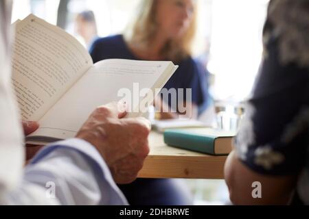 Cropped image of friends sitting on the floor and playing cards Stock ...