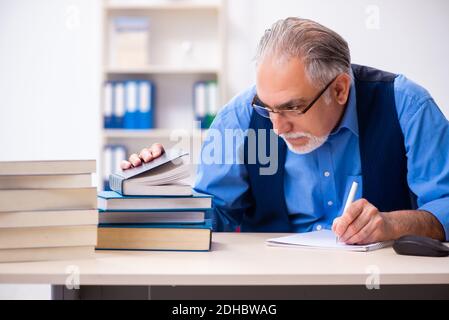 Old male author writing books with the feather Stock Photo - Alamy