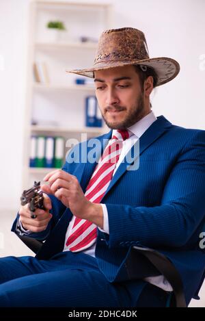 Businessman cowboy working in the office Stock Photo - Alamy