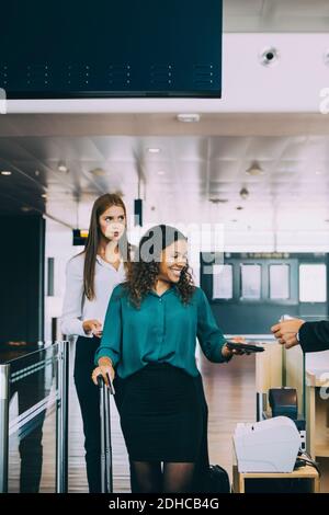 Airport Check-in Counter: Female Airline Agents Checking Documents and ...