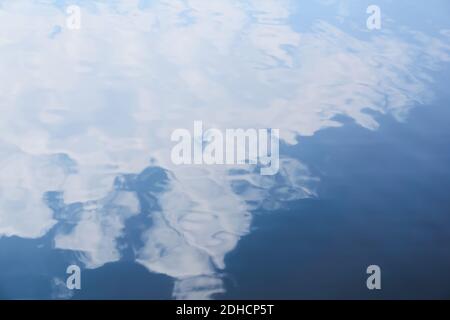 Gentle blue waves, current on water's surface or wake from boat ...