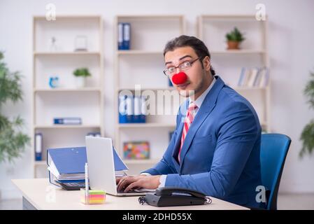 Funny employee clown working in the office room Stock Photo - Alamy