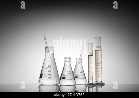A closeup shot of transparent laboratory flasks, beakers, and tubes ...