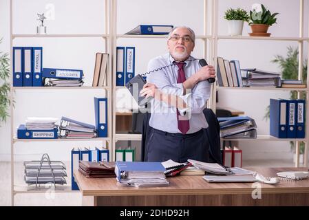 Old employee unhappy with excessive work Stock Photo - Alamy