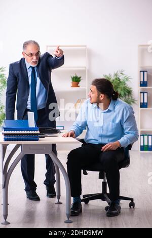 Old employer and young assistant in bullying concept Stock Photo - Alamy
