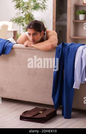 Young employee getting up late at home Stock Photo - Alamy