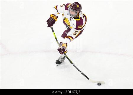 Minnesota-Duluth defenseman Wyatt Kaiser (5) skating down the ice ...