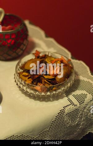 Orange and red potpourri in glass vase Stock Photo - Alamy