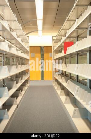 Empty library shelves with one red book Stock Photo - Alamy