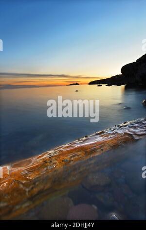 A petrified tree in a beach close to Sigri town, in one of the Geoparks ...