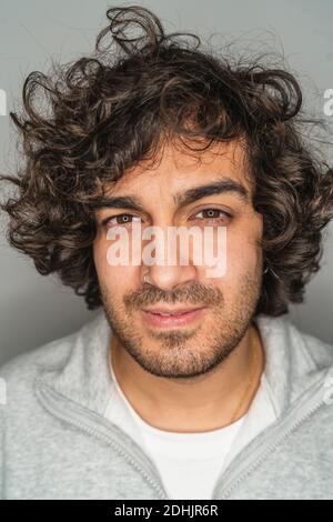 Portrait of handsome man against gray background Stock Photo - Alamy