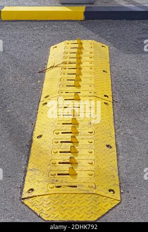 One way yellow traffic spikes at parking lot exit Stock Photo - Alamy