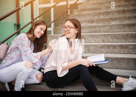 Two schoolgirls doing their homework outdoors Stock Photo - Alamy